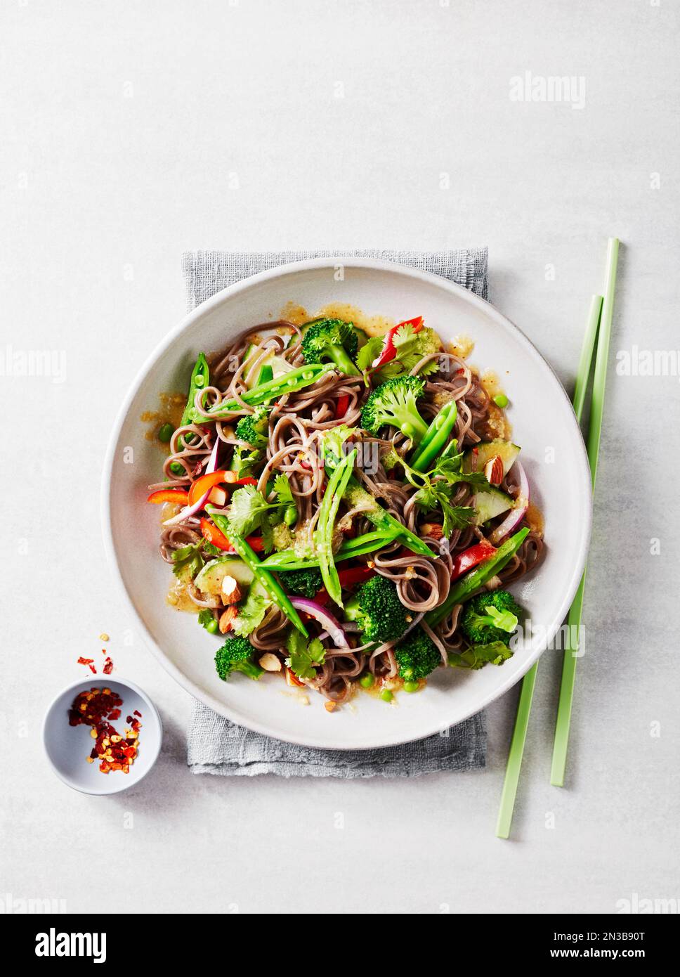 Soba noodle salad with chopsticks and chili flakes Stock Photo - Alamy