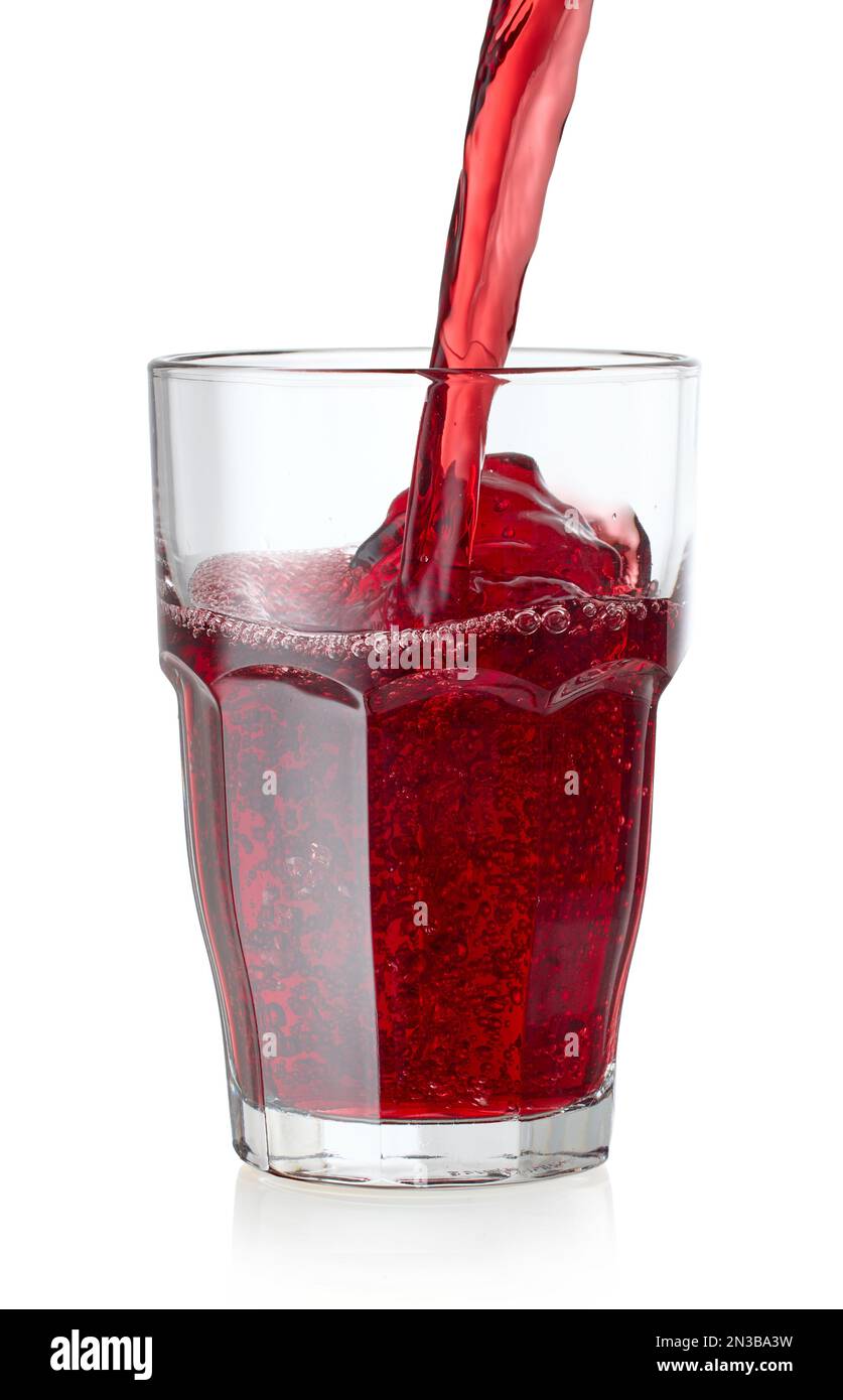 red grape juice pouring into glass isolated on white background Stock ...
