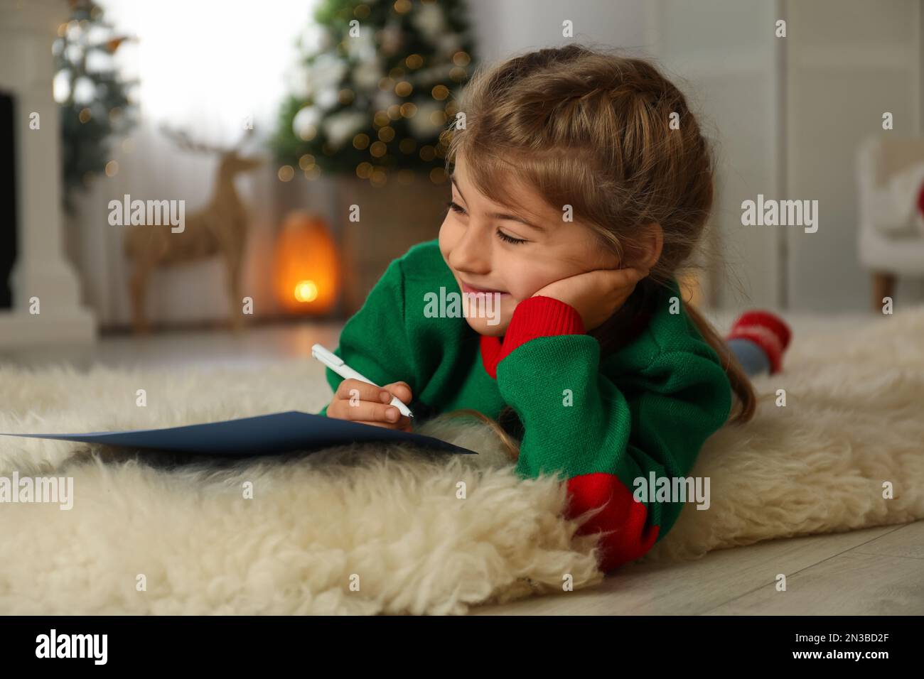 Cute child writing letter to Santa Claus at home. Christmas tradition ...
