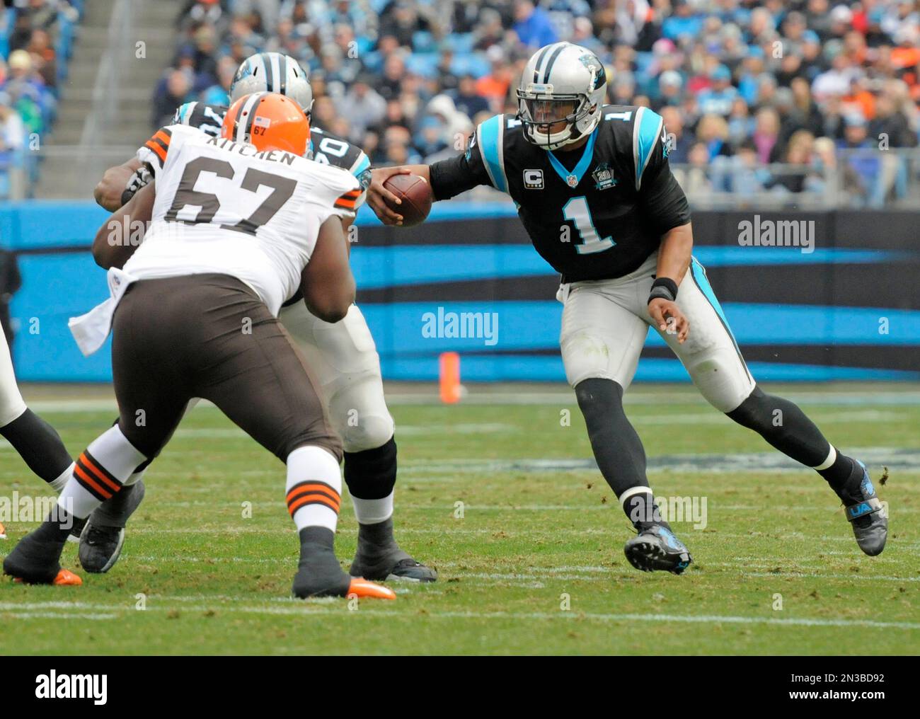 Carolina Panthers' Cam Newton (1) scrambles as Cleveland Browns' Ishmaa ...