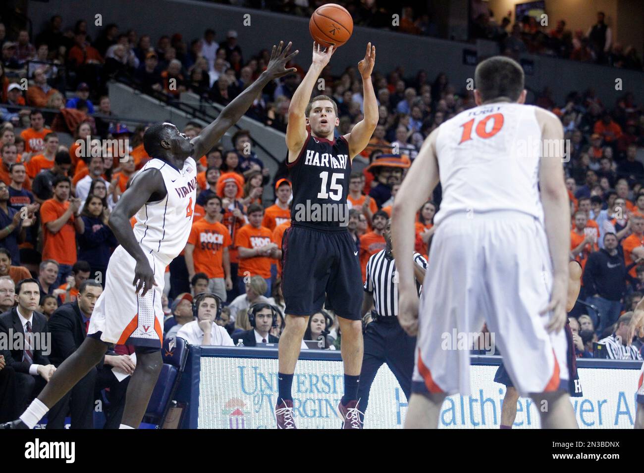 Harvard guard Corbin Miller (15) takes an outside shot as Virginia ...