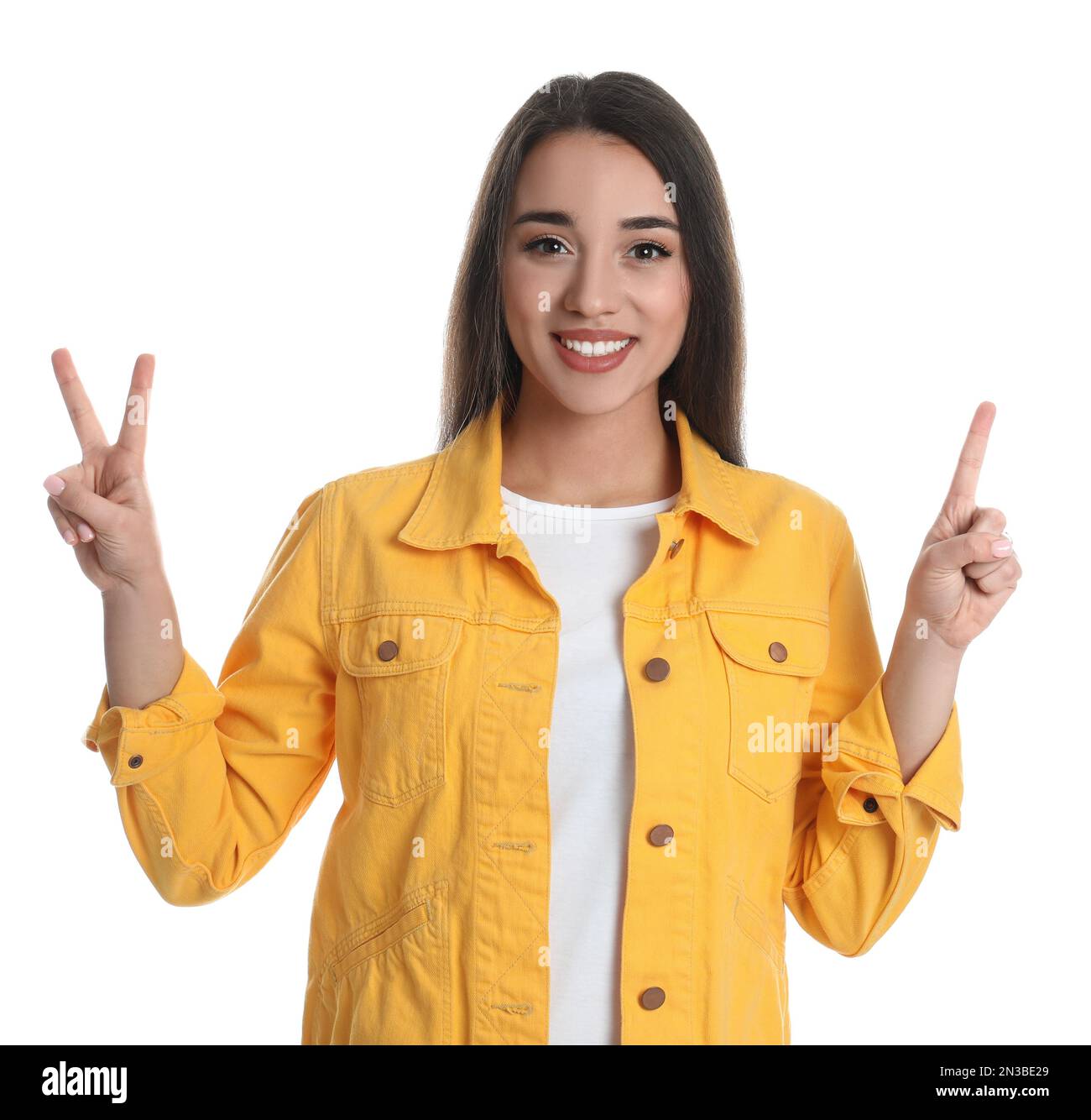 Woman in yellow jacket showing number three with her hands on white background Stock Photo - Alamy