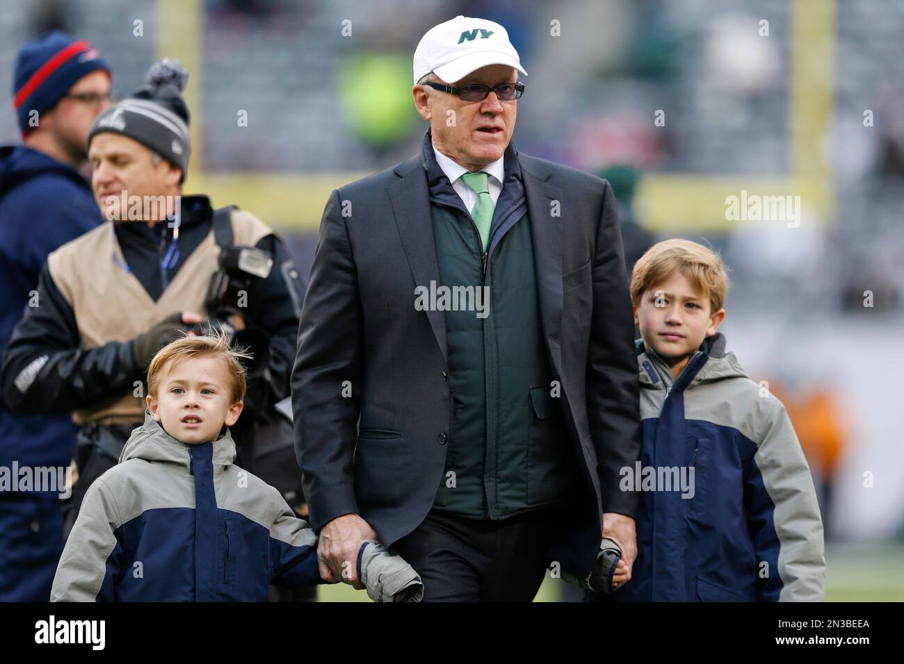 New York Jets owner Woody Johnson walks on the field as his team warms up before and NFL ...