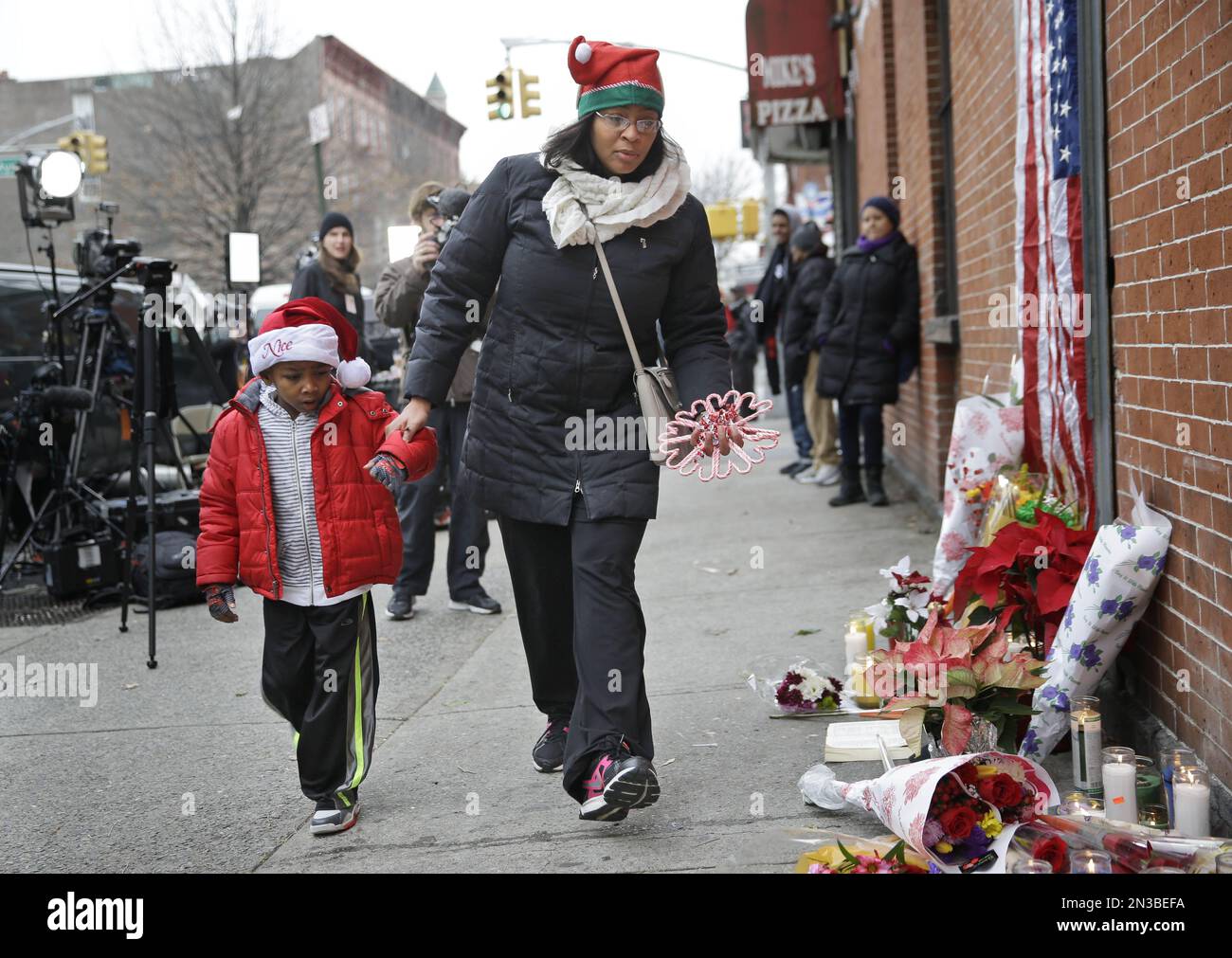 Danielle Pinckney and her son, Rashid Pinckney, 5, leave candy canes at ...