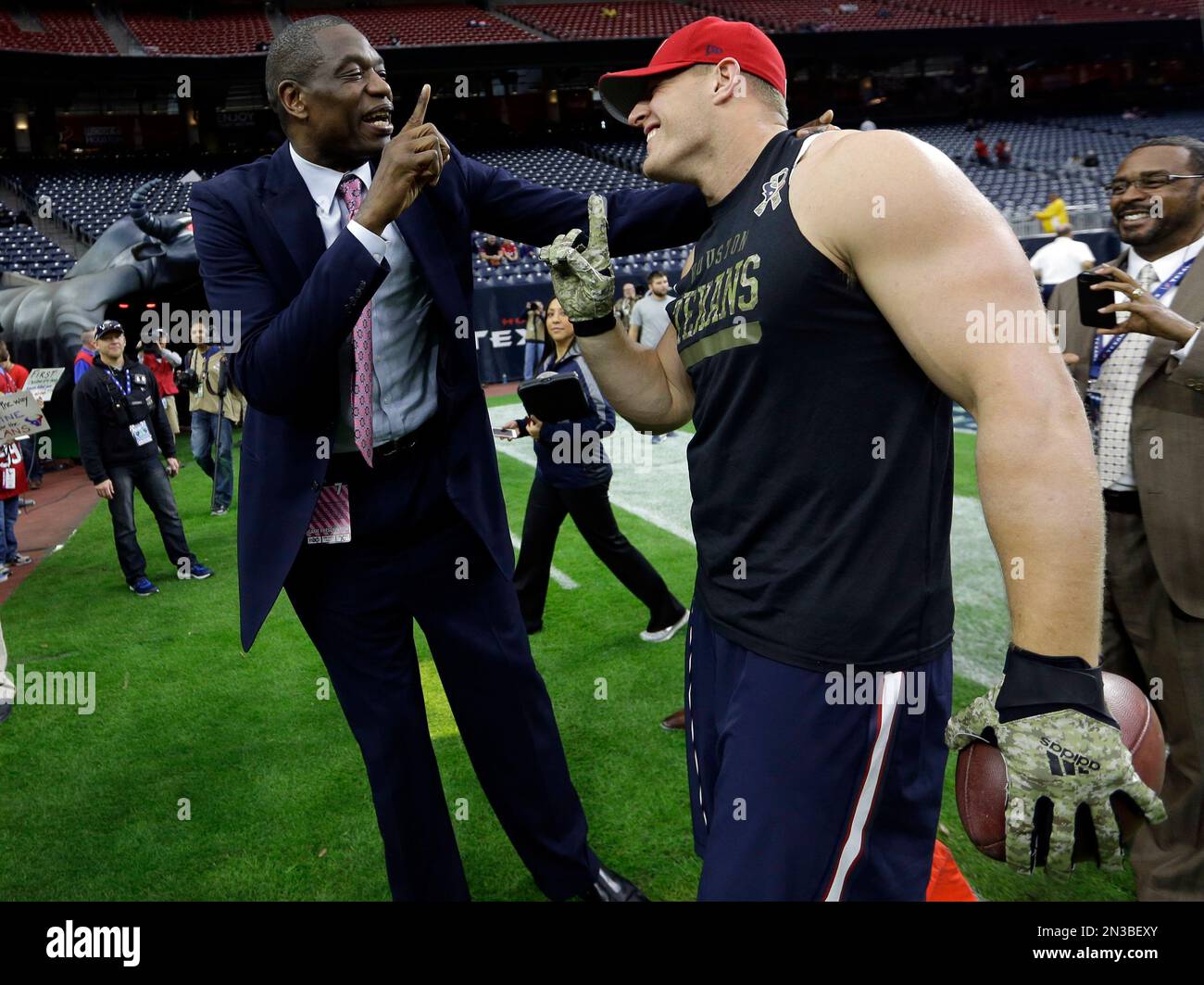 Former NBA player Dikembe Mutombo, left, does his signature finger wave ...