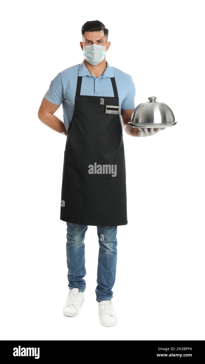Waiter in medical face mask holding tray with lid on white background ...