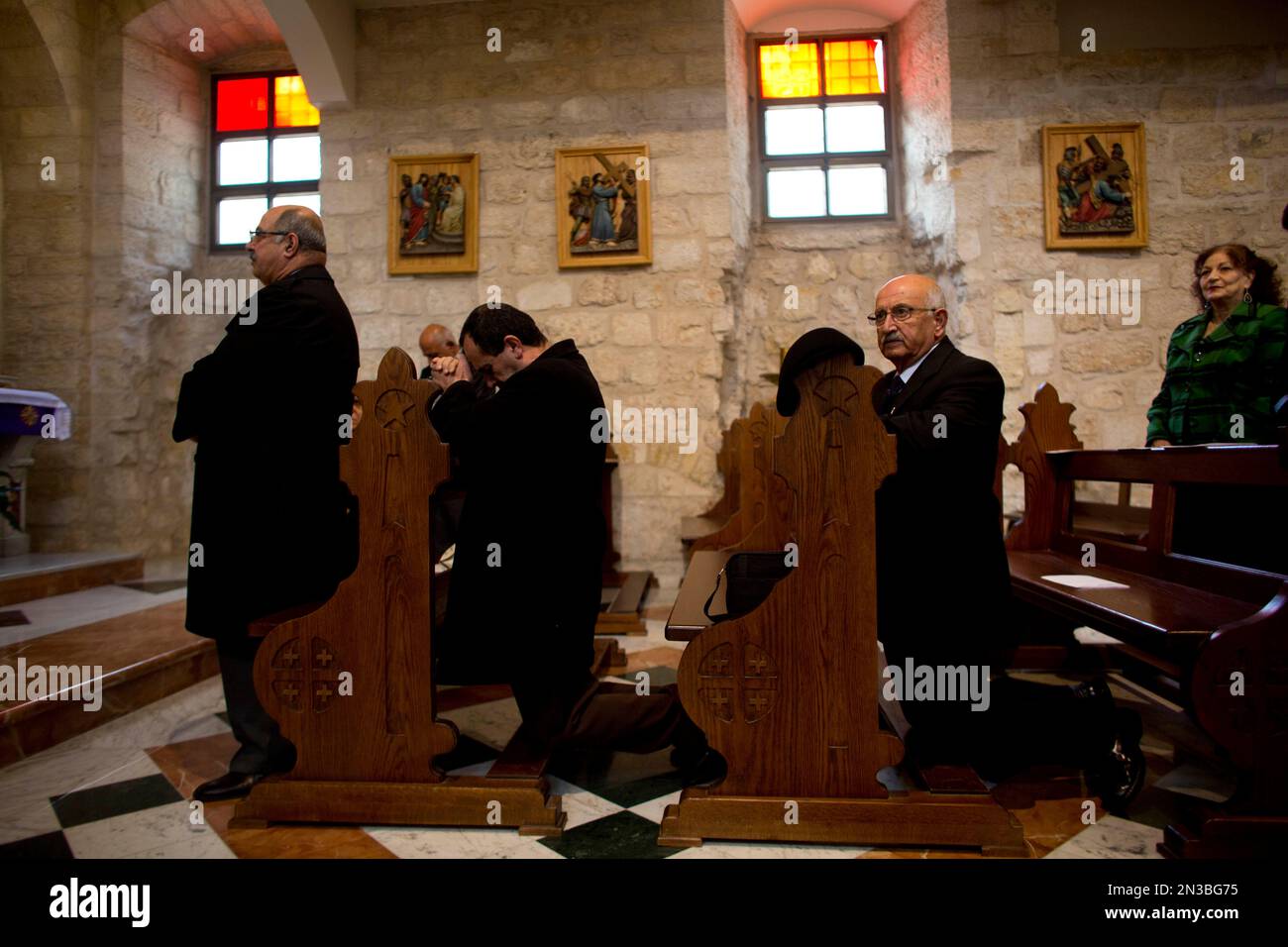 Palestinian Christians pray during the last Sunday Mass before ...