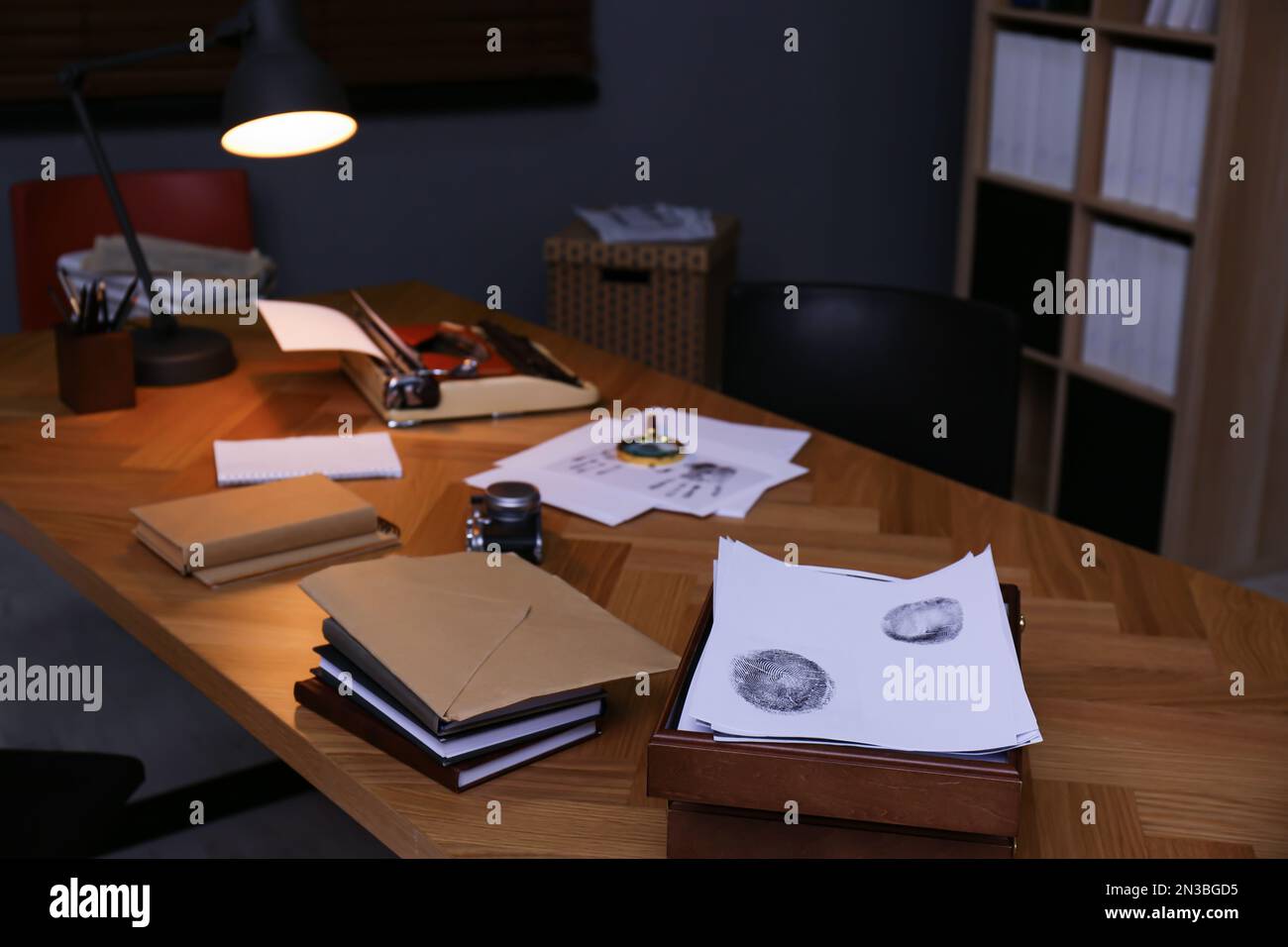 Typewriter, fingerprints and papers on desk in office. Detective's ...