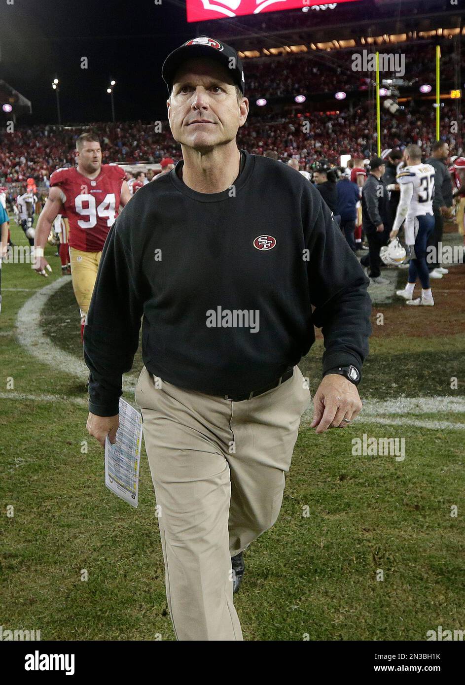 San Francisco 49ers coach Jim Harbaugh walks off the field after the ...