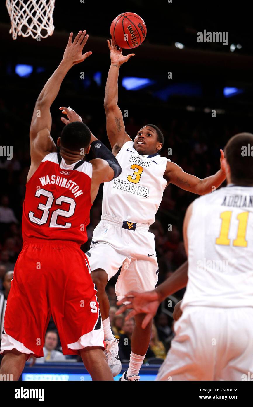 West Virginia's Juwan Staten (3) shoots against North Carolina State's ...