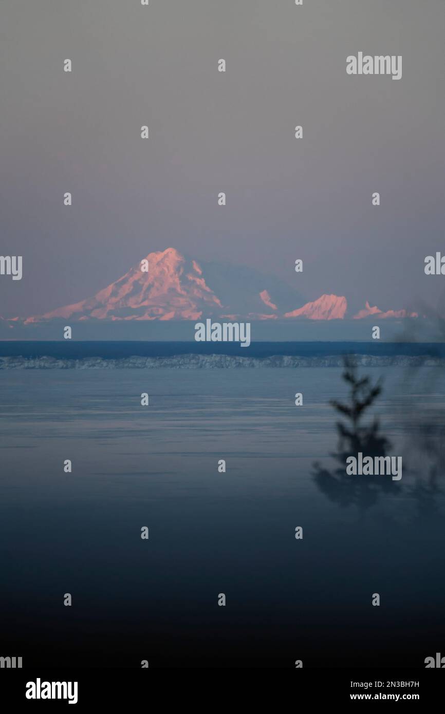 The volcano Mt. Redoubt towers above Cook Inlet, near Anchorage Alaska ...
