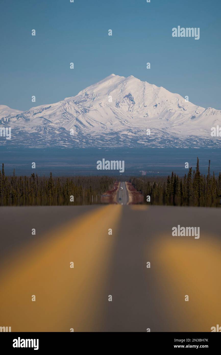 Snow and glacier covered Mt. Drum rises above the Glenn Highway and the ...