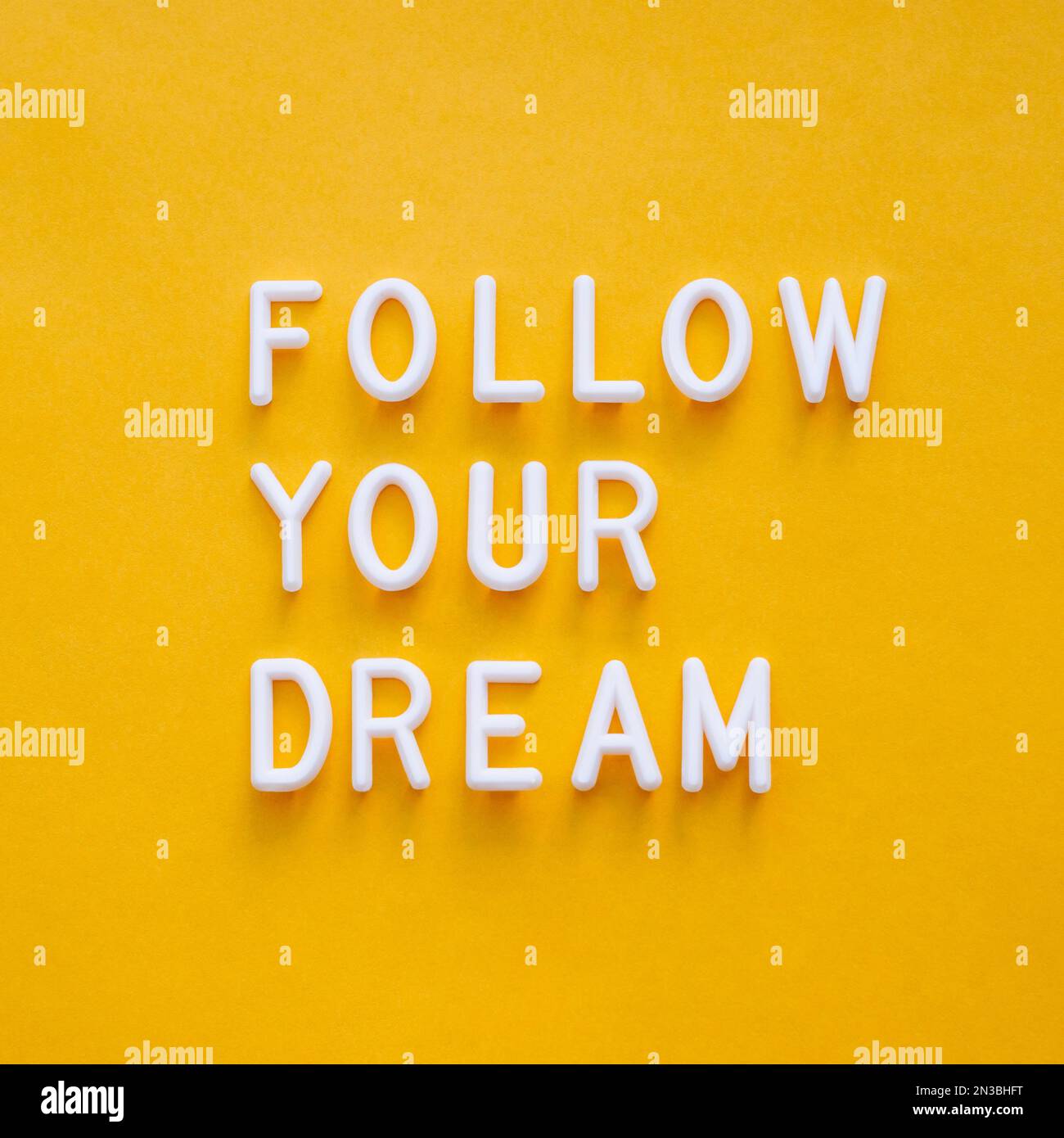 Follow your dream. Motivating and inspiring phrase on bright yellow ...