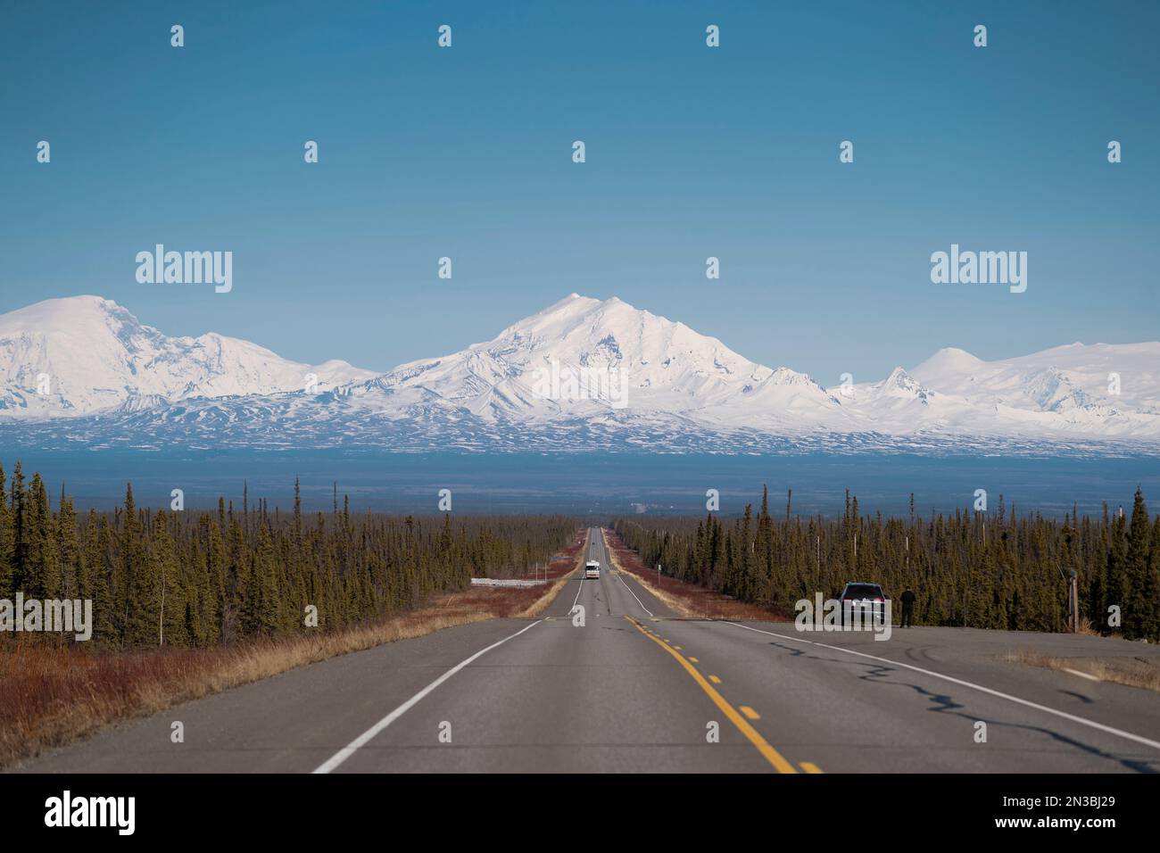 Snow and glacier covered Mt. Drum rises above the Glenn Highway and the ...