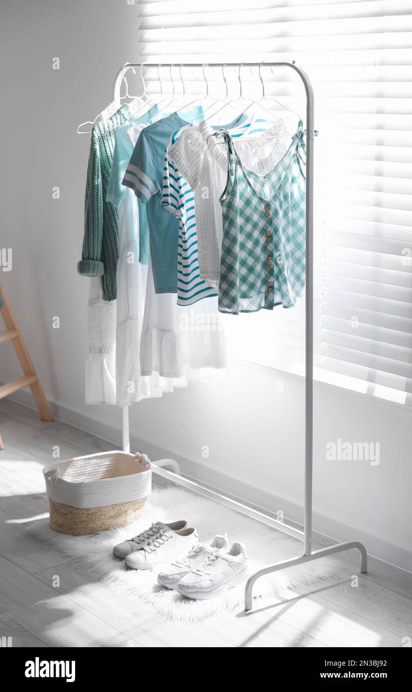 Rack with stylish women's clothes indoors. Interior design Stock Photo ...