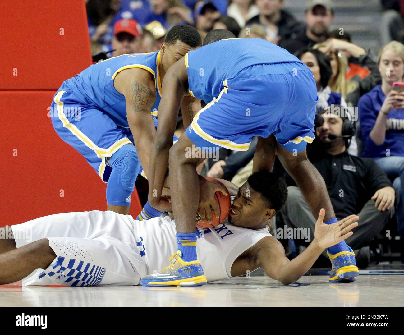 Kentucky center Dakari Johnson, bottom, battles UCLA guard Norman ...