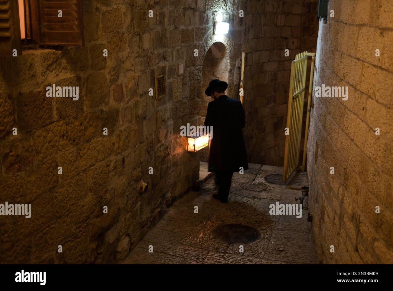An ultra Orthodox Jew lights candles during the Jewish holiday of ...