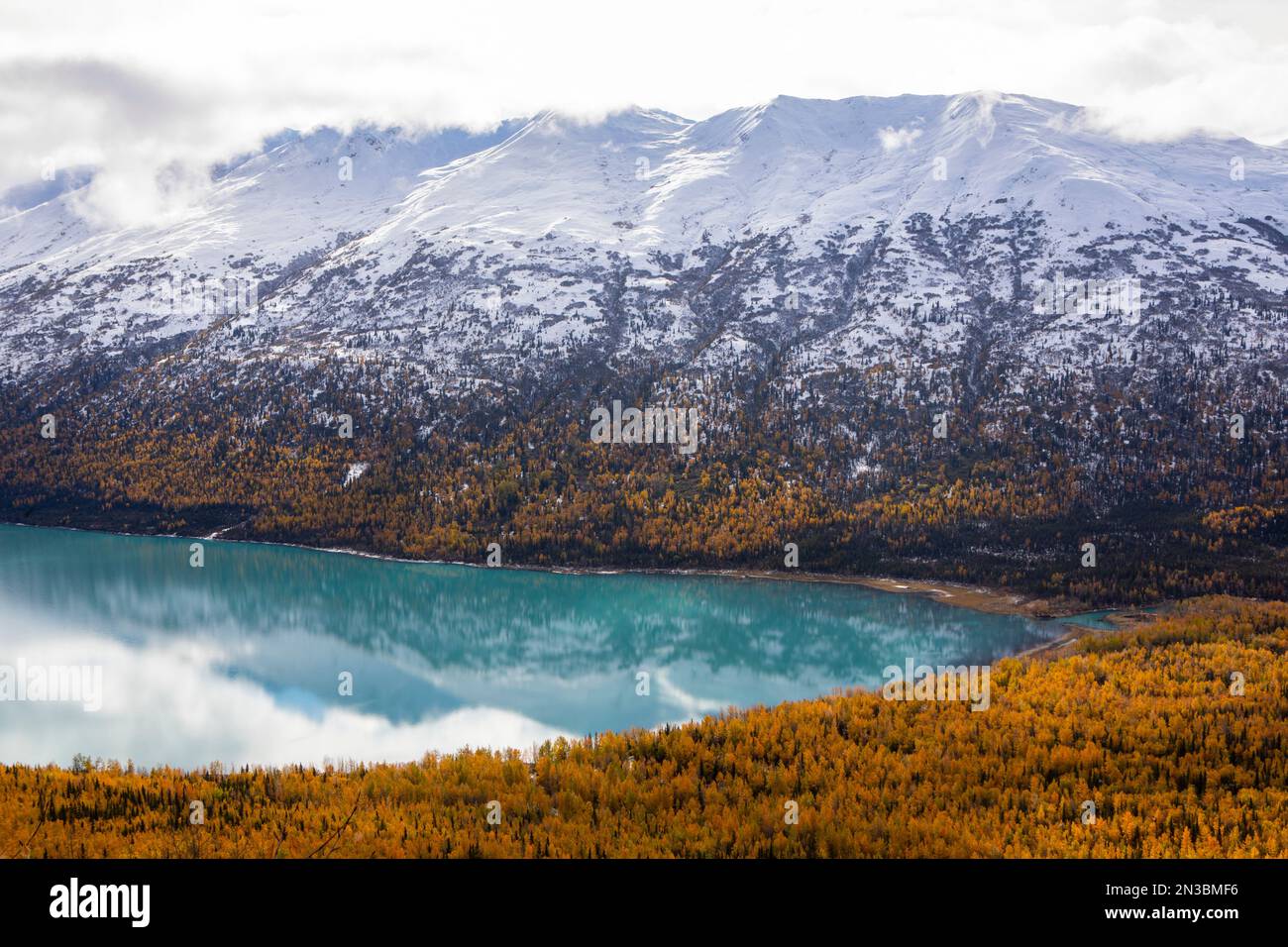 Bright orange/yellow fall colors contrast with the glacier blue of ...