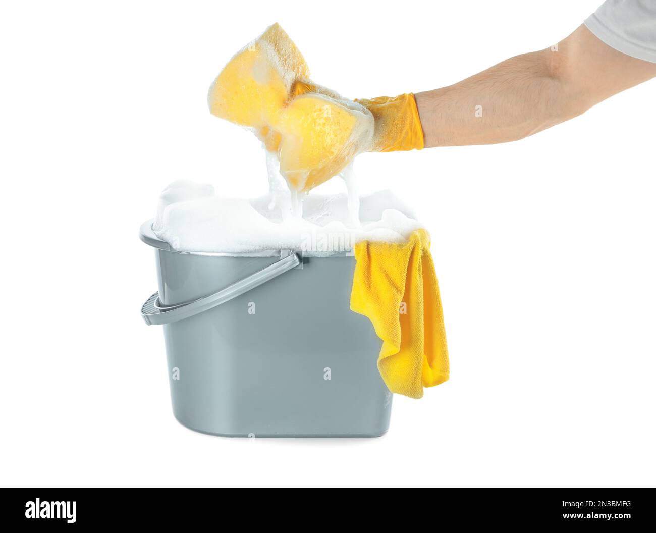 Man holding sponge over bucket with foam on white background, closeup ...