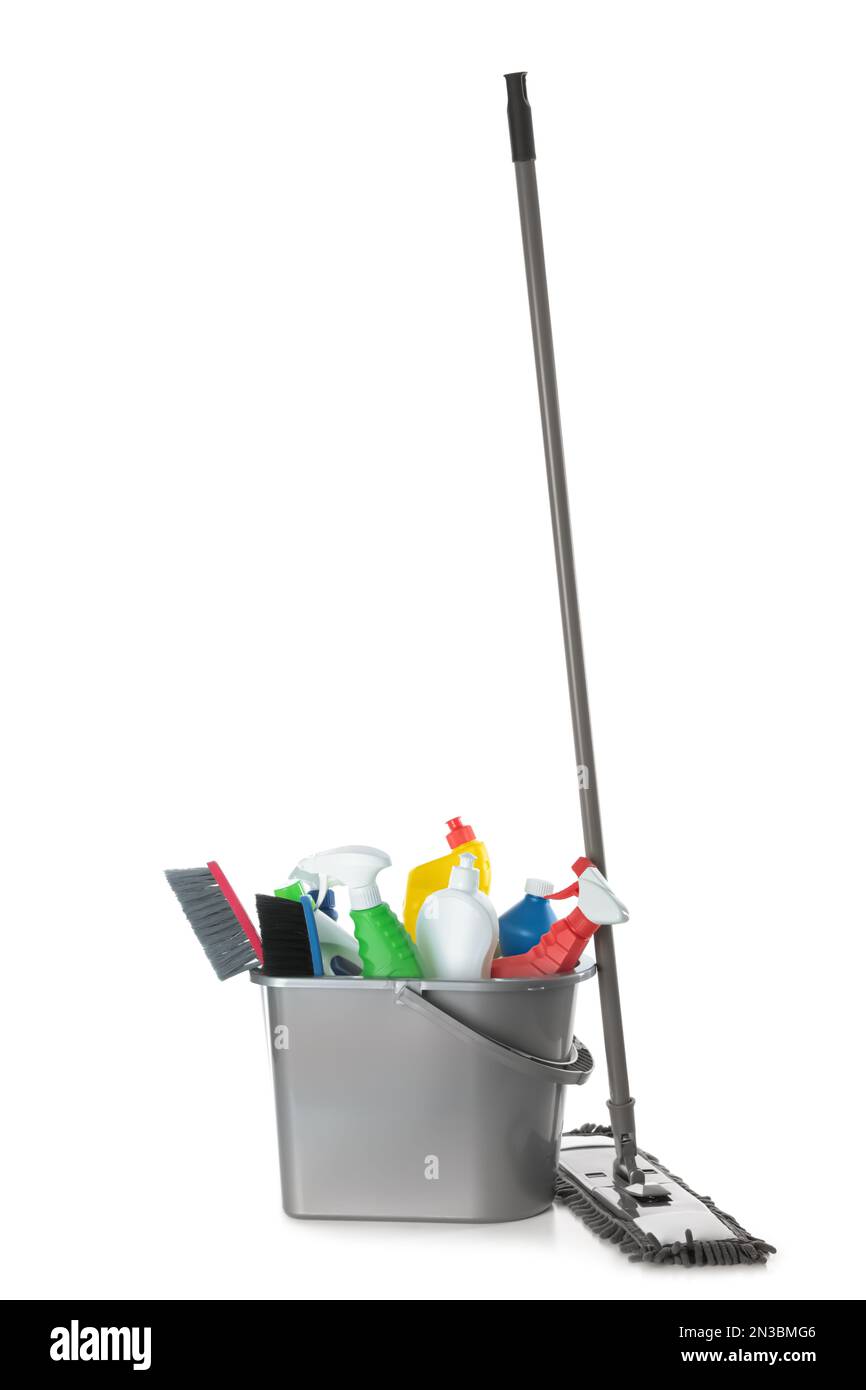 Mop and plastic bucket with different cleaning supplies on white ...