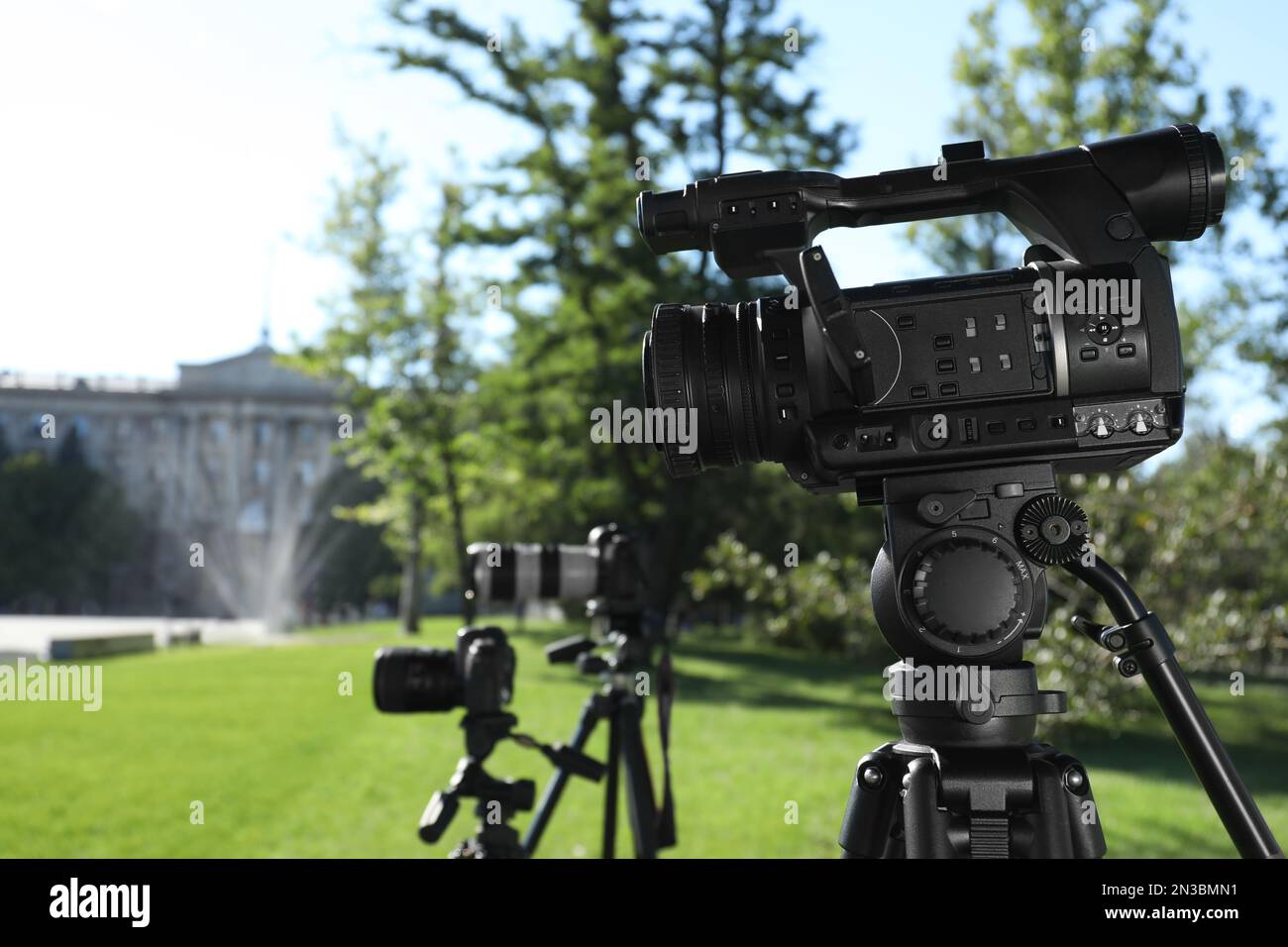 Modern video cameras in park. Professional media equipment Stock Photo ...