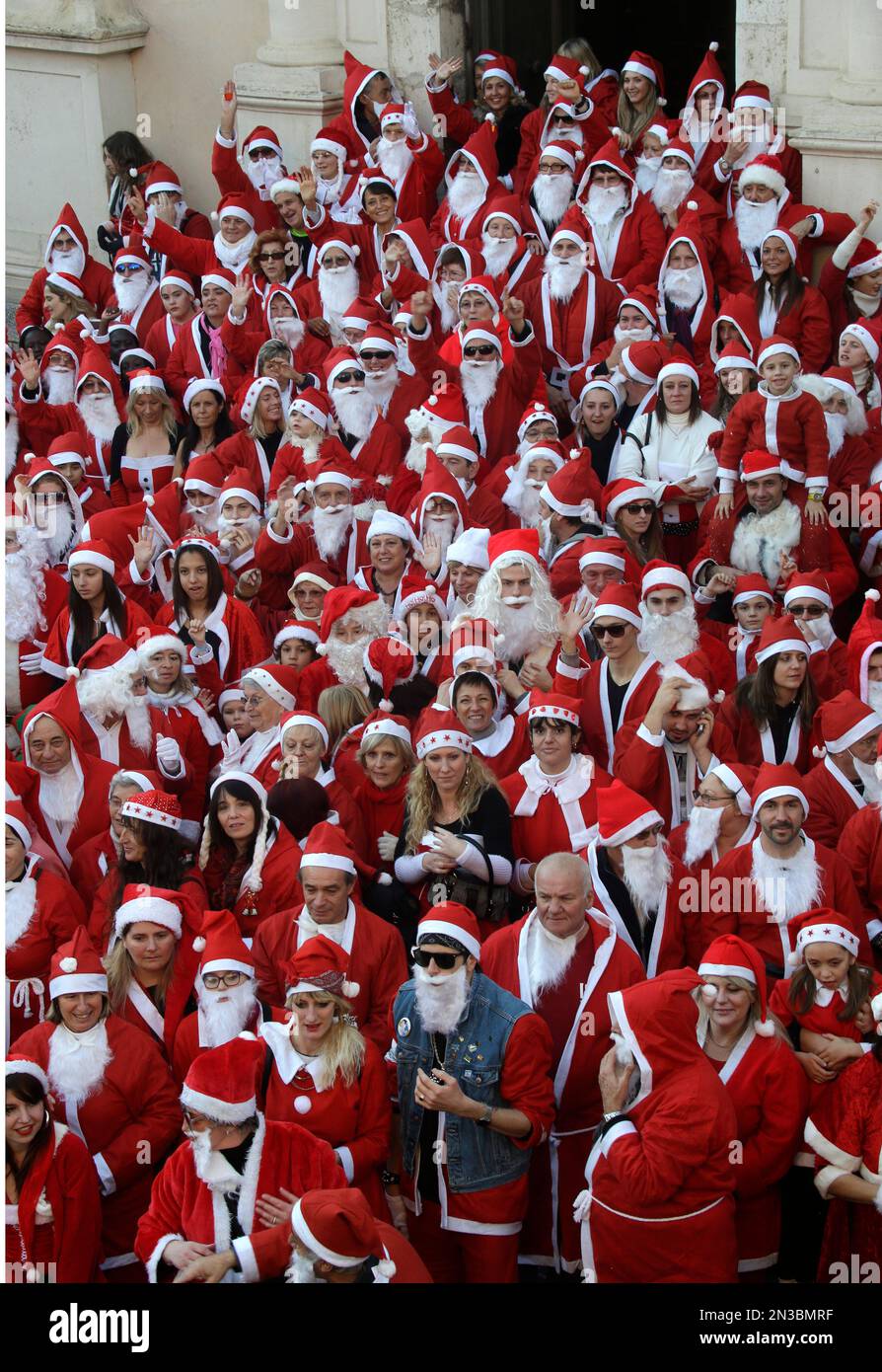Around 250 people dressed in Santa Claus costumes pose for ...