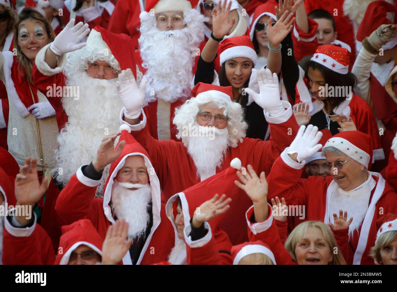 Around 250 people dressed in Santa Claus costumes pose for ...
