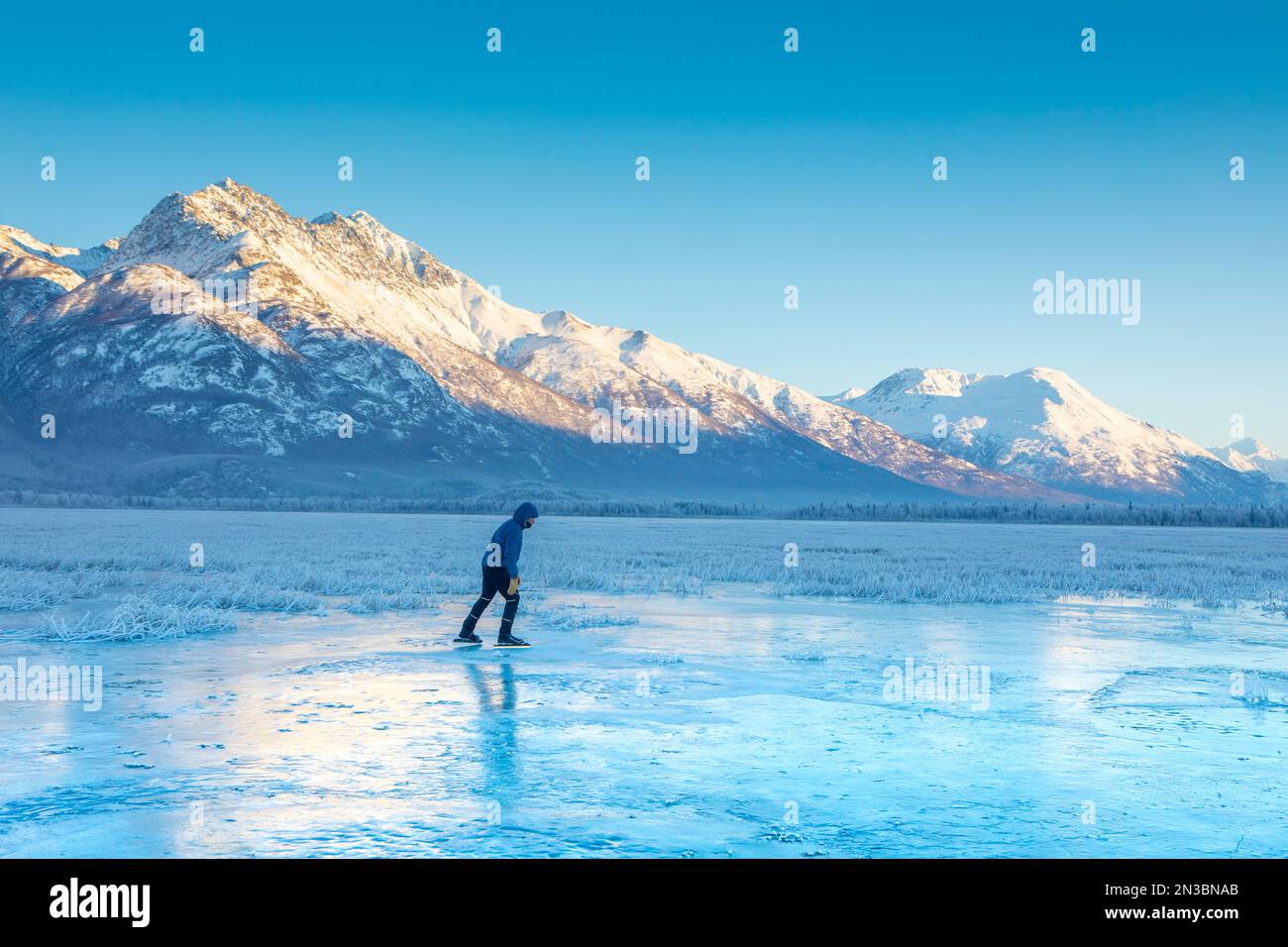 A caucasian man backcountry ice skating, nordic blading on Gull Lake in ...