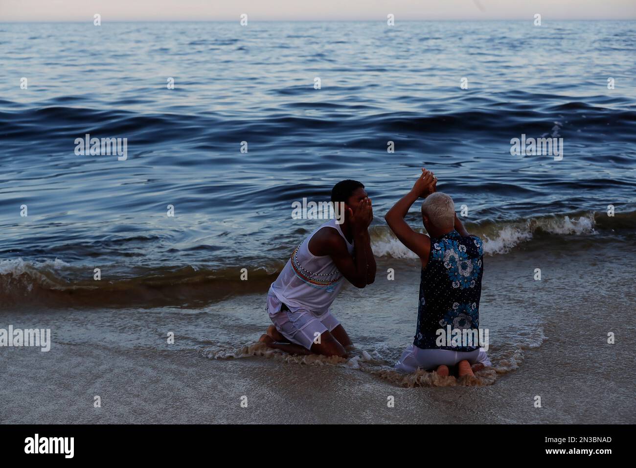 Devotees of the sea goddess Yemanja pray in the waters of Diabo beach ...