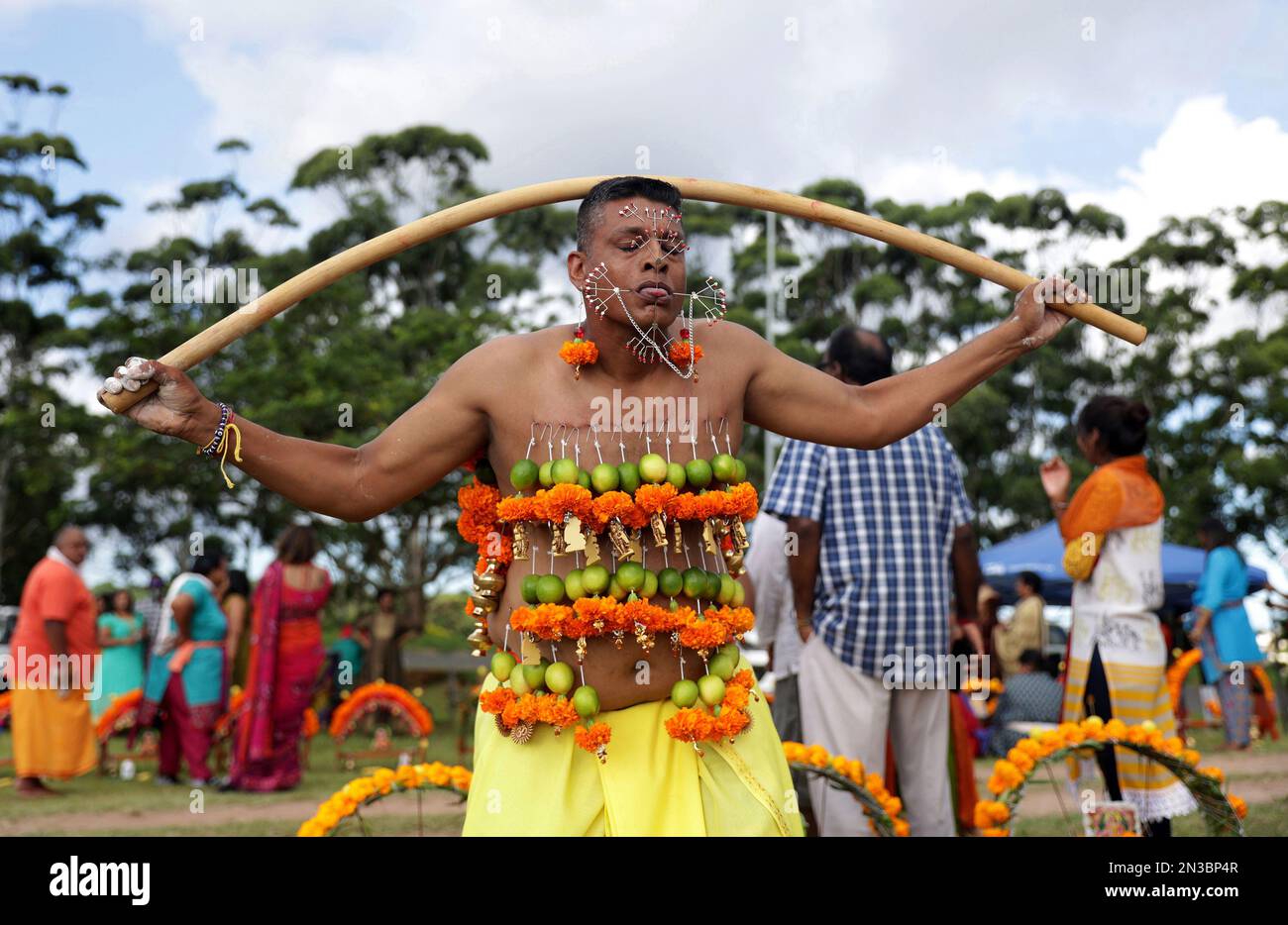 A Hindu devotee from Havenside Grammadave Alayam temple reacts as he is ...