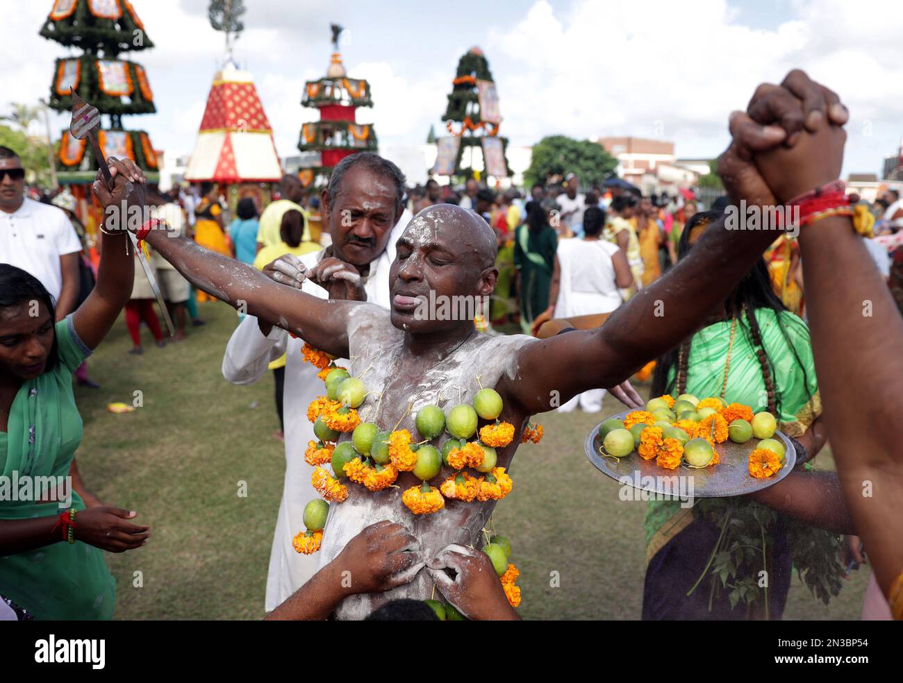 A Hindu devotee from Siva Sathi Alayam temple, is hooked with spikes ...