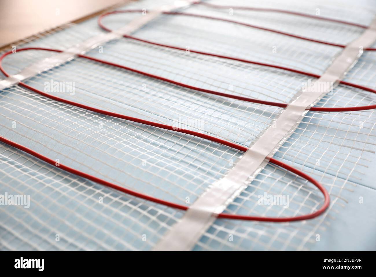 Installation of modern underfloor trace heating system indoors, closeup ...