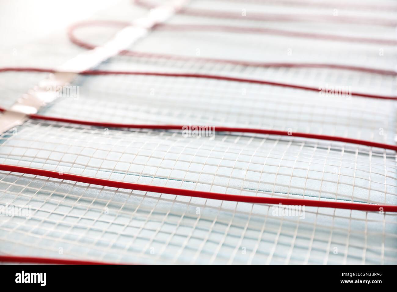 Installation of modern underfloor trace heating system indoors, closeup ...