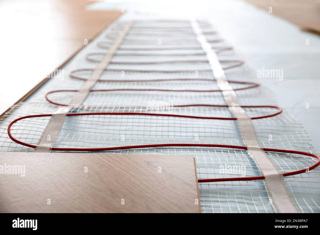 Installation of modern underfloor trace heating system indoors, closeup ...