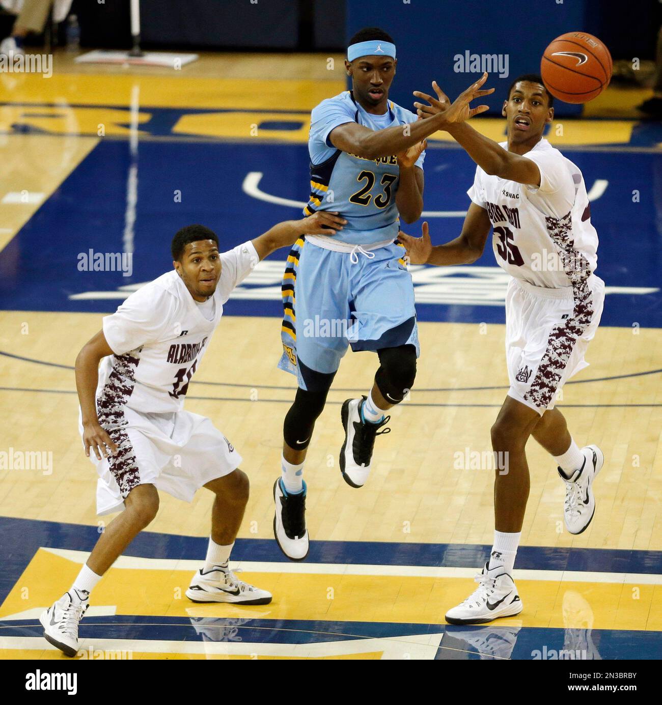 Marquette's JaJuan Johnson (23) passes between Alabama A&M's Rakiya ...