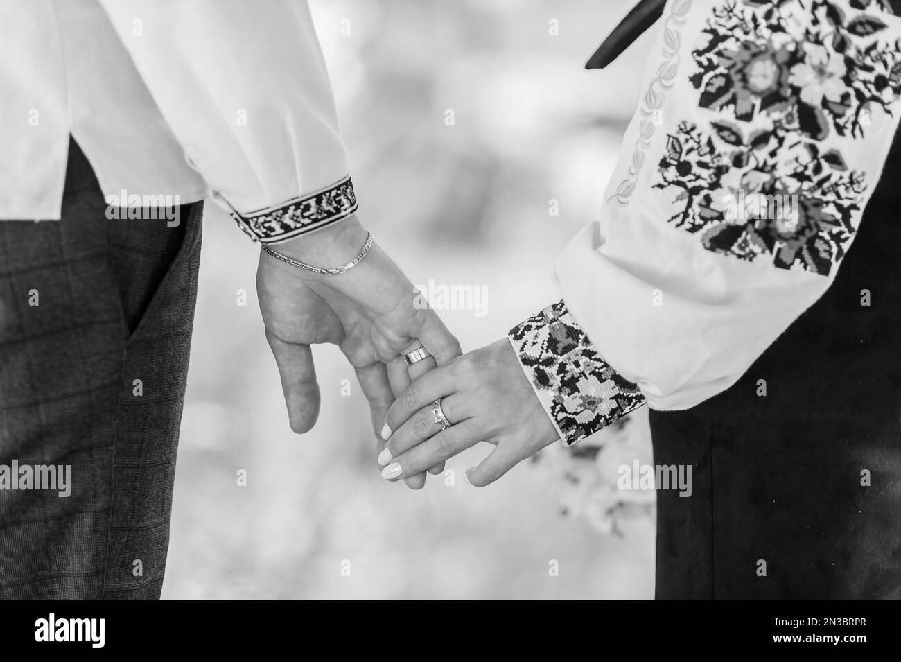 The boy and the girl walk holding hands. Man holding woman's hand Stock ...