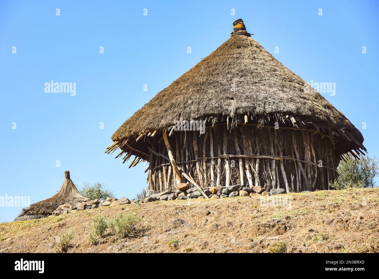 Close-up view of African round huts against the blue sky, traditional ...
