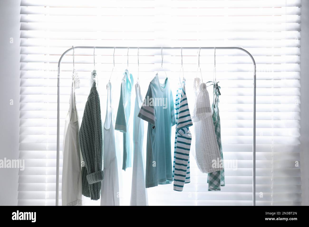 Rack with stylish women's clothes indoors. Interior design Stock Photo ...