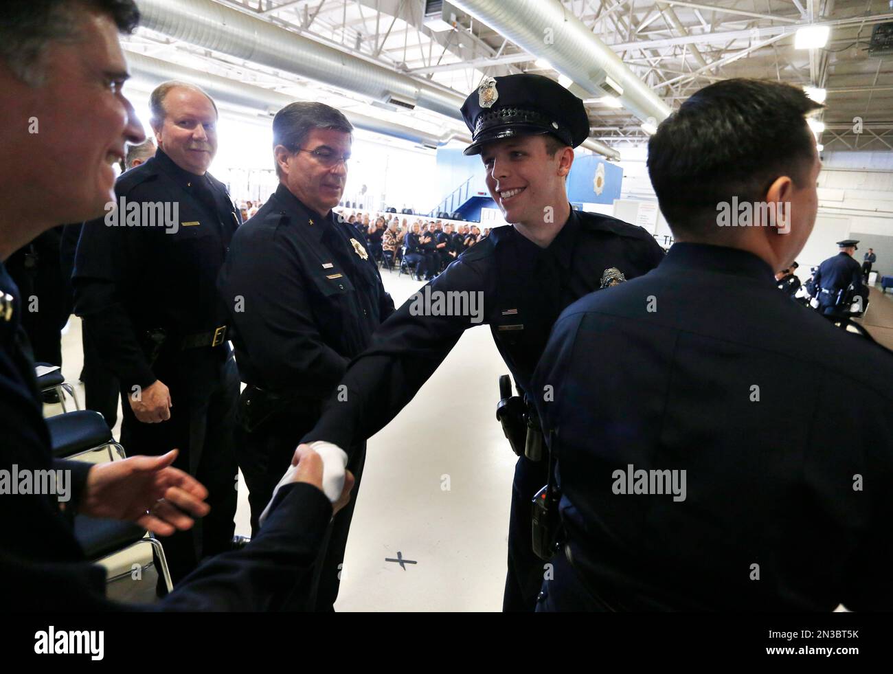Graduating police officer Gavin Whitman shakes hands with superior ...