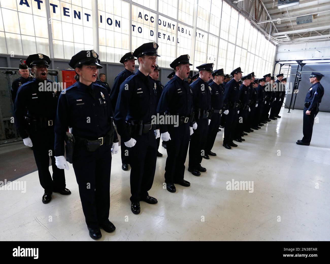 Graduating police officers participate in a police recruit graduation ...