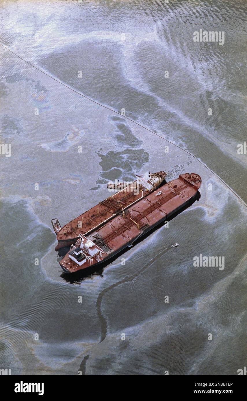 The Exxon Baton Rouge, smaller ship, attempts to off-load crude from ...