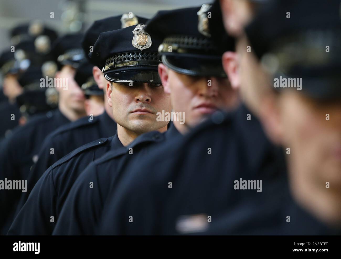 Graduating police cadets stand at attention, during the police recruit ...
