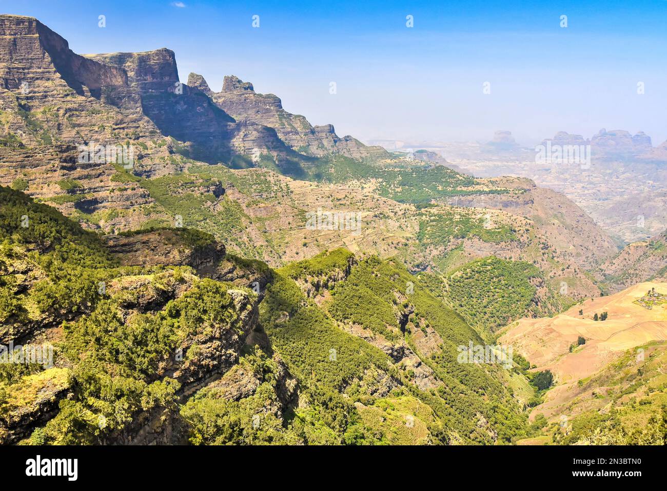 Scenic view of mountain peaks and rocky cliffs covered with trees and ...