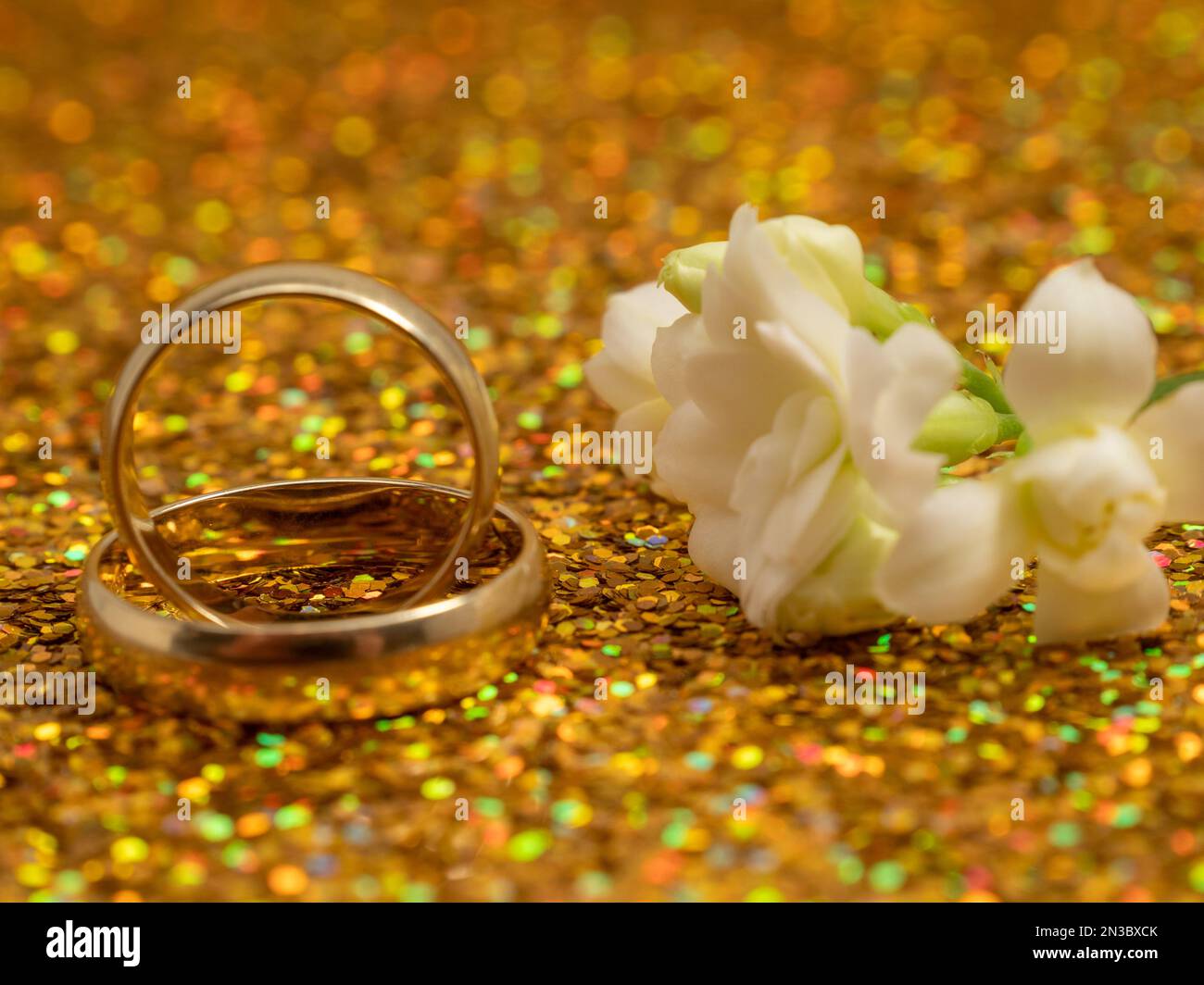 Wedding rings on a golden shiny background. Gold rings. Close-up Stock ...