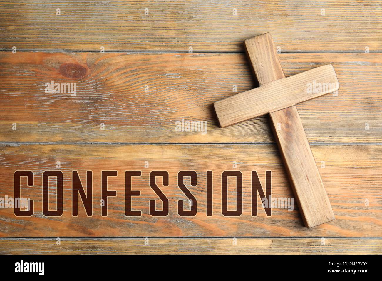 Christian cross and word Confession on wooden background, top view ...