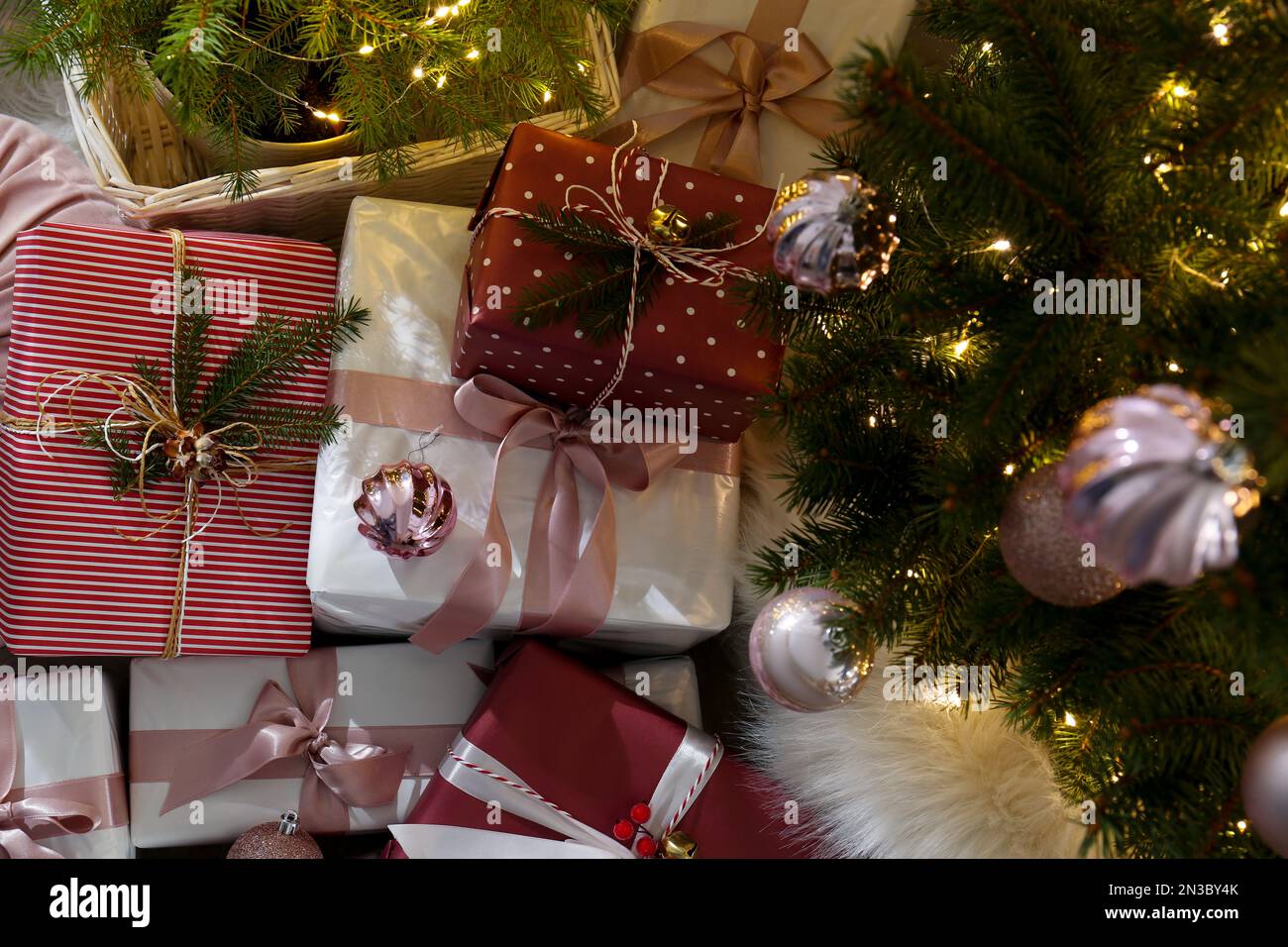 Gift boxes under Christmas tree, above view Stock Photo - Alamy