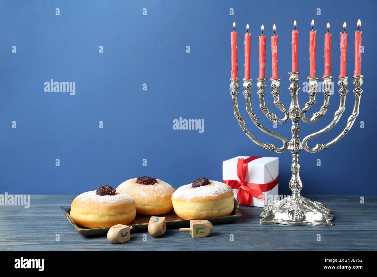 Silver menorah, dreidels with He, Pe, Nun, Gimel letters, gift box and ...