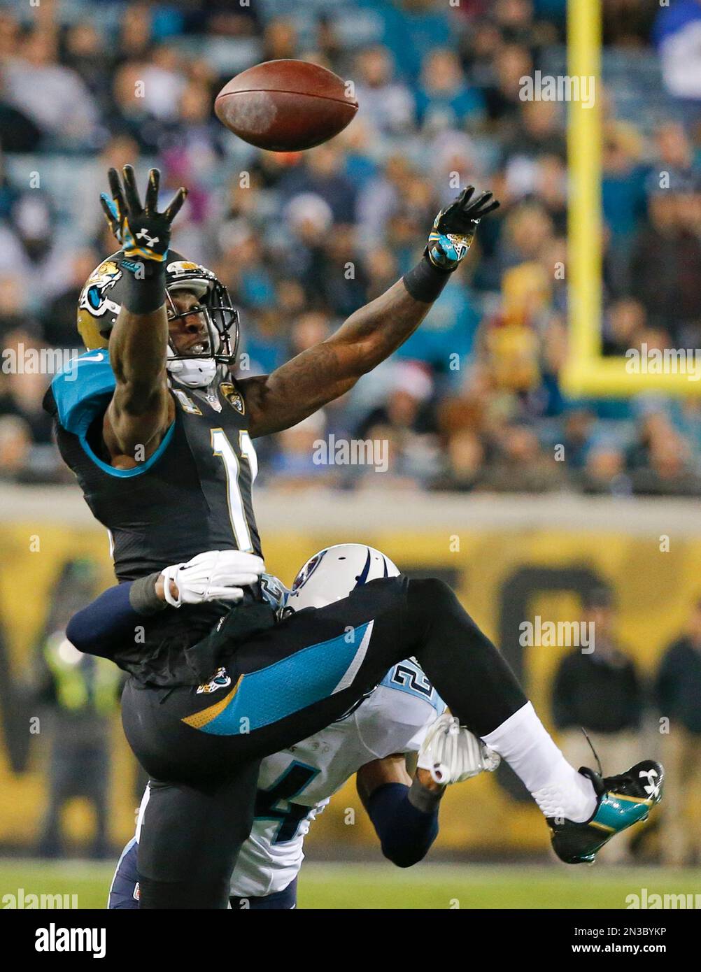 Tennessee Titans cornerback Coty Sensabaugh, bottom, breaks up a pass ...