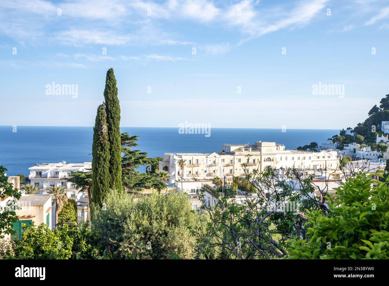 View through the trees on a cliff overlooking the Grand Hotel Quisisana ...