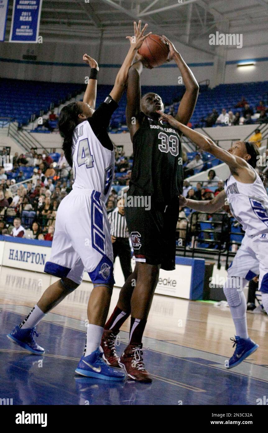 South Carolina's Elem Ibiam, center, shoots between Hampton's Brielle ...